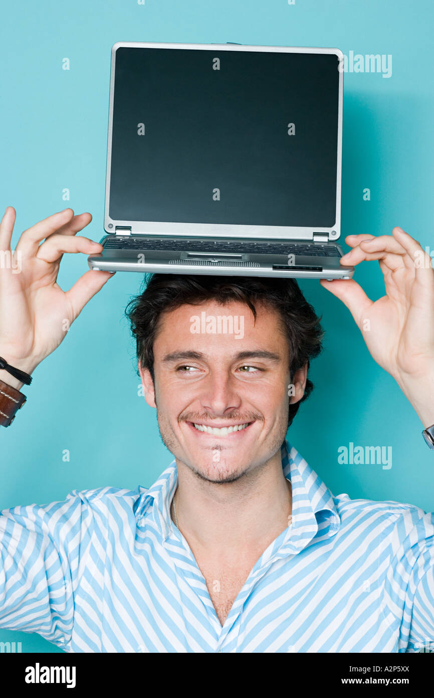 Man with laptop on his head Stock Photo - Alamy