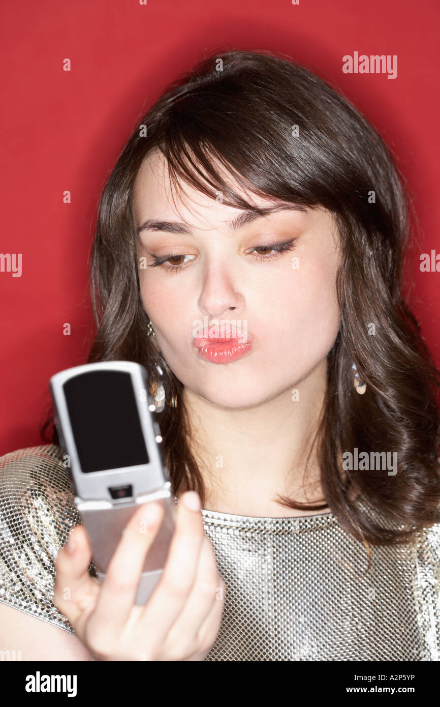 Woman pouting at cellphone Stock Photo - Alamy