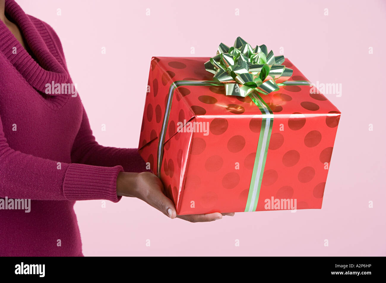 Woman holding present Stock Photo - Alamy