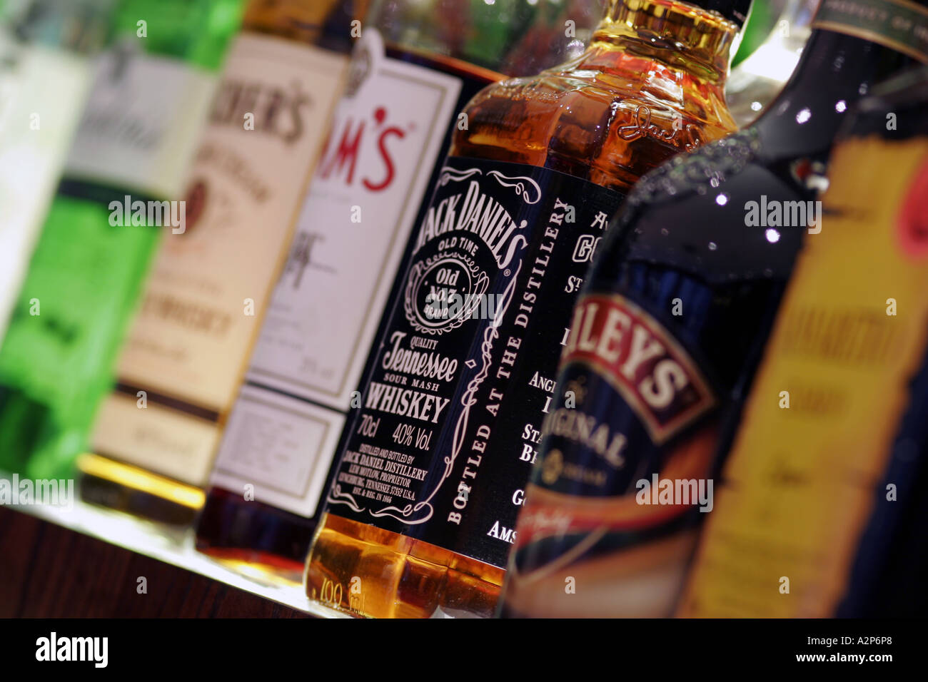 Row of famous alcohol brands on a back bar display Stock Photo - Alamy