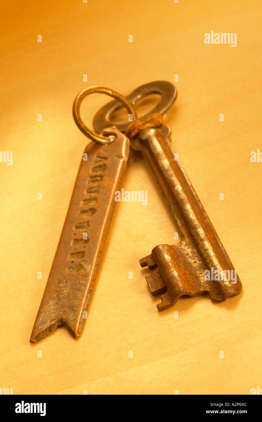 Metal Key with Tag on yellow background Stock Photo - Alamy