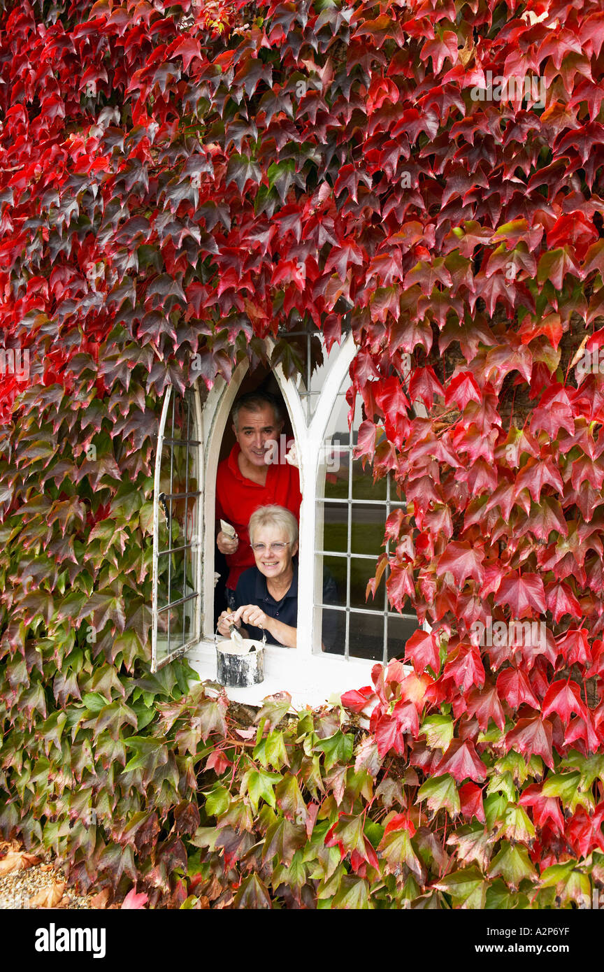 Retired Senior 60-70 years Couple looking through gothic style window ...