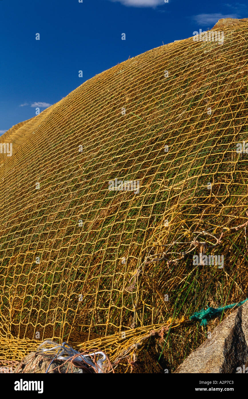 gold colored straw and netting holding a rick of peat/turf on the irish ...