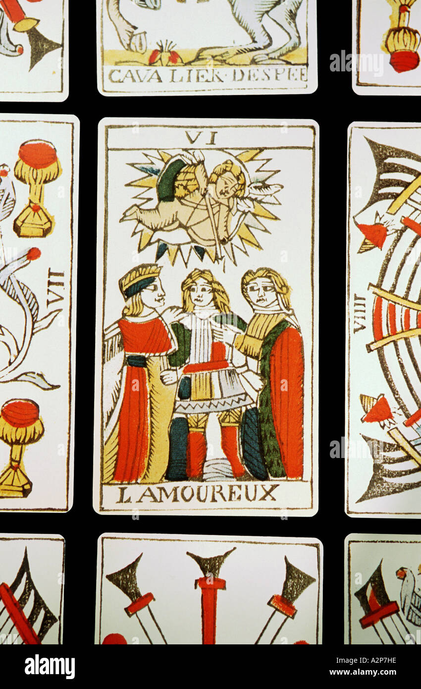 A set of tarot cards laid out with the Lovers in the central position ...
