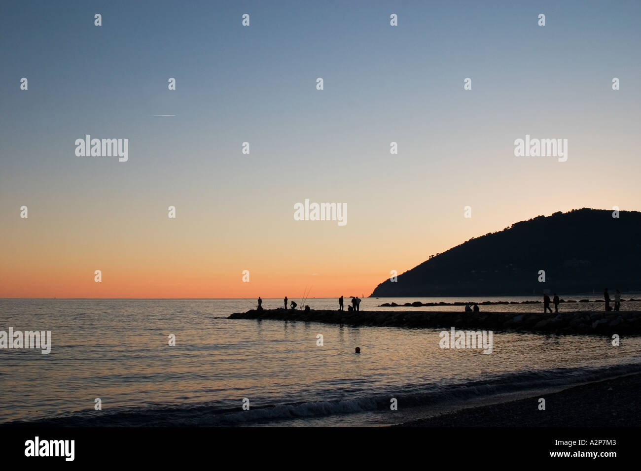 Italian Riviera Ligure sunset with fishers on the pier Stock Photo - Alamy