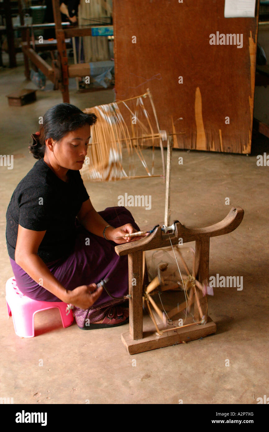 Laos Vientiane woman hand spinning silk and winding onto bobbin Stock ...