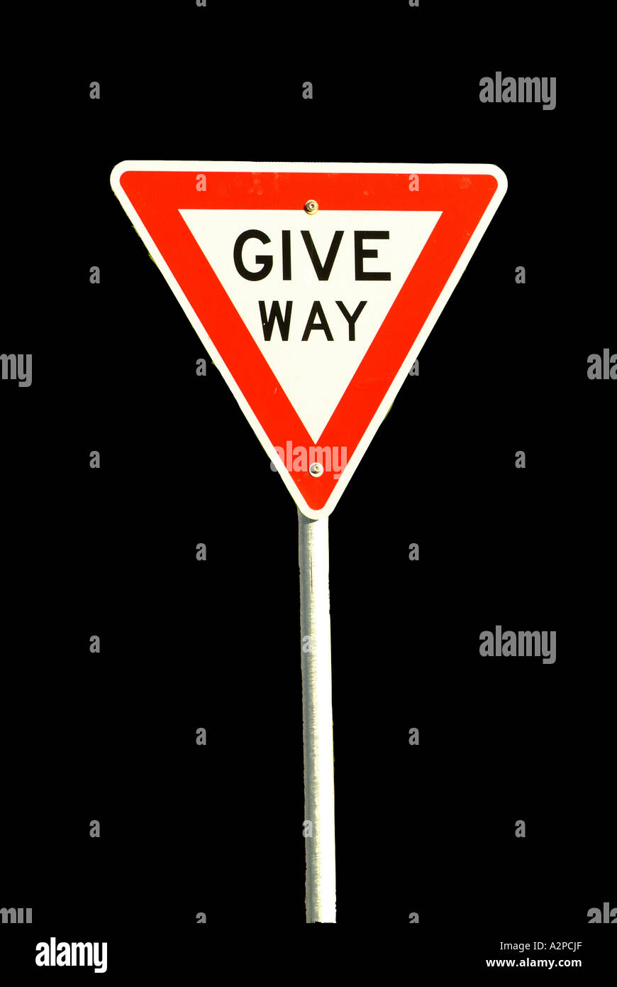 Give Way street road sign with black background Stock Photo - Alamy