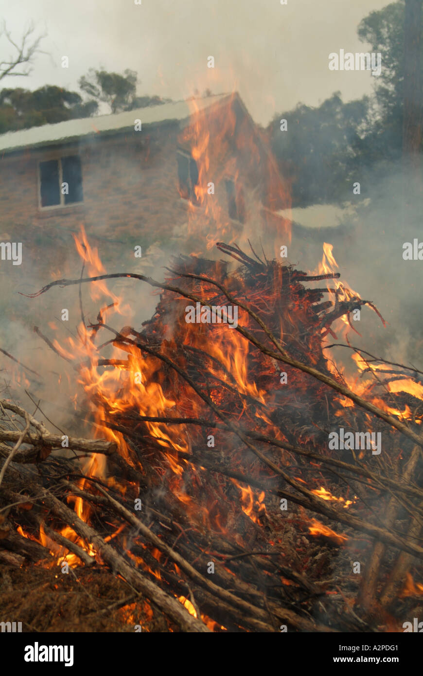 House threatened by bushfire with smoke and flames Stock Photo - Alamy