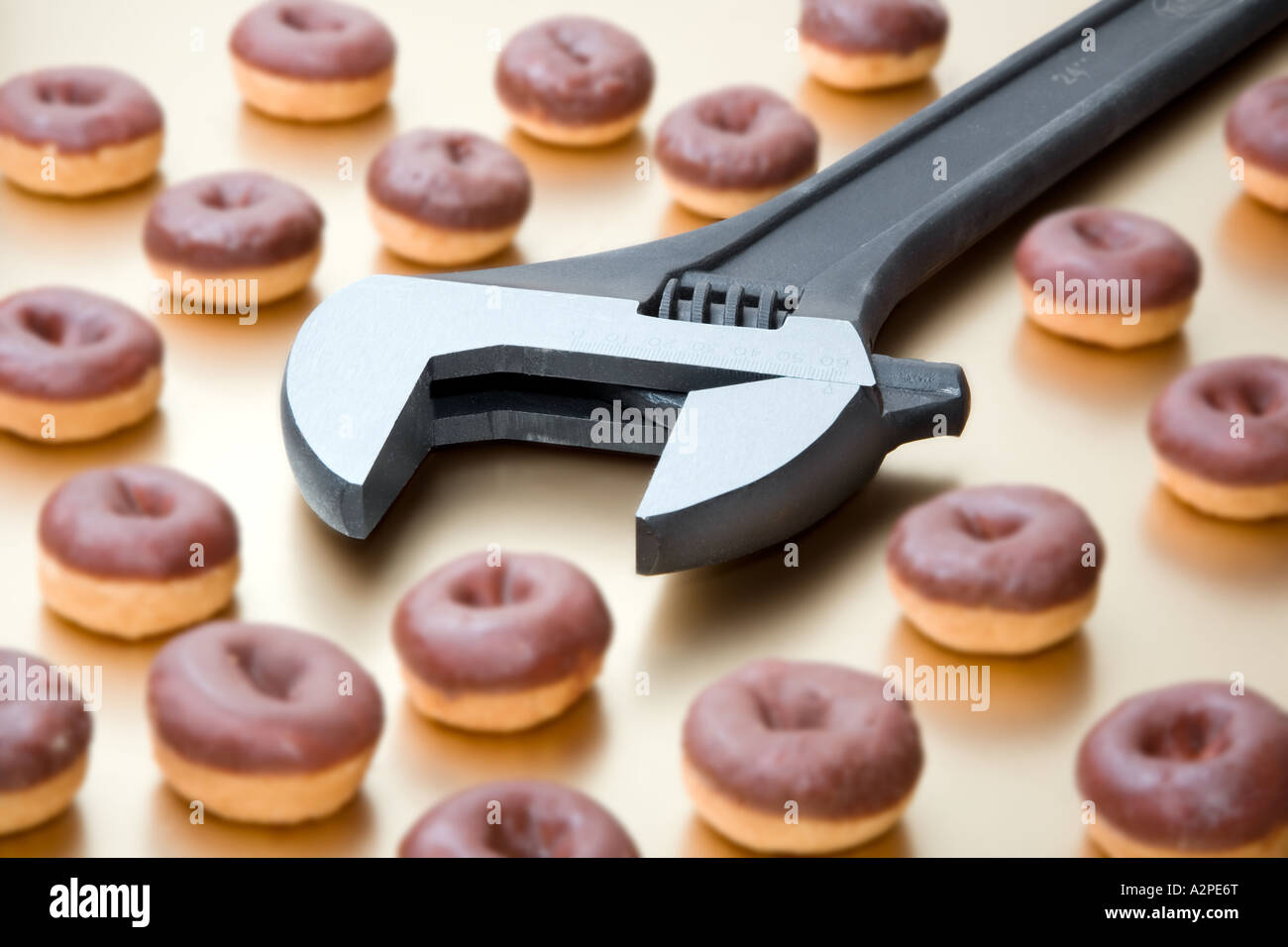 Mini doughnuts around an adjustable spanner Stock Photo - Alamy