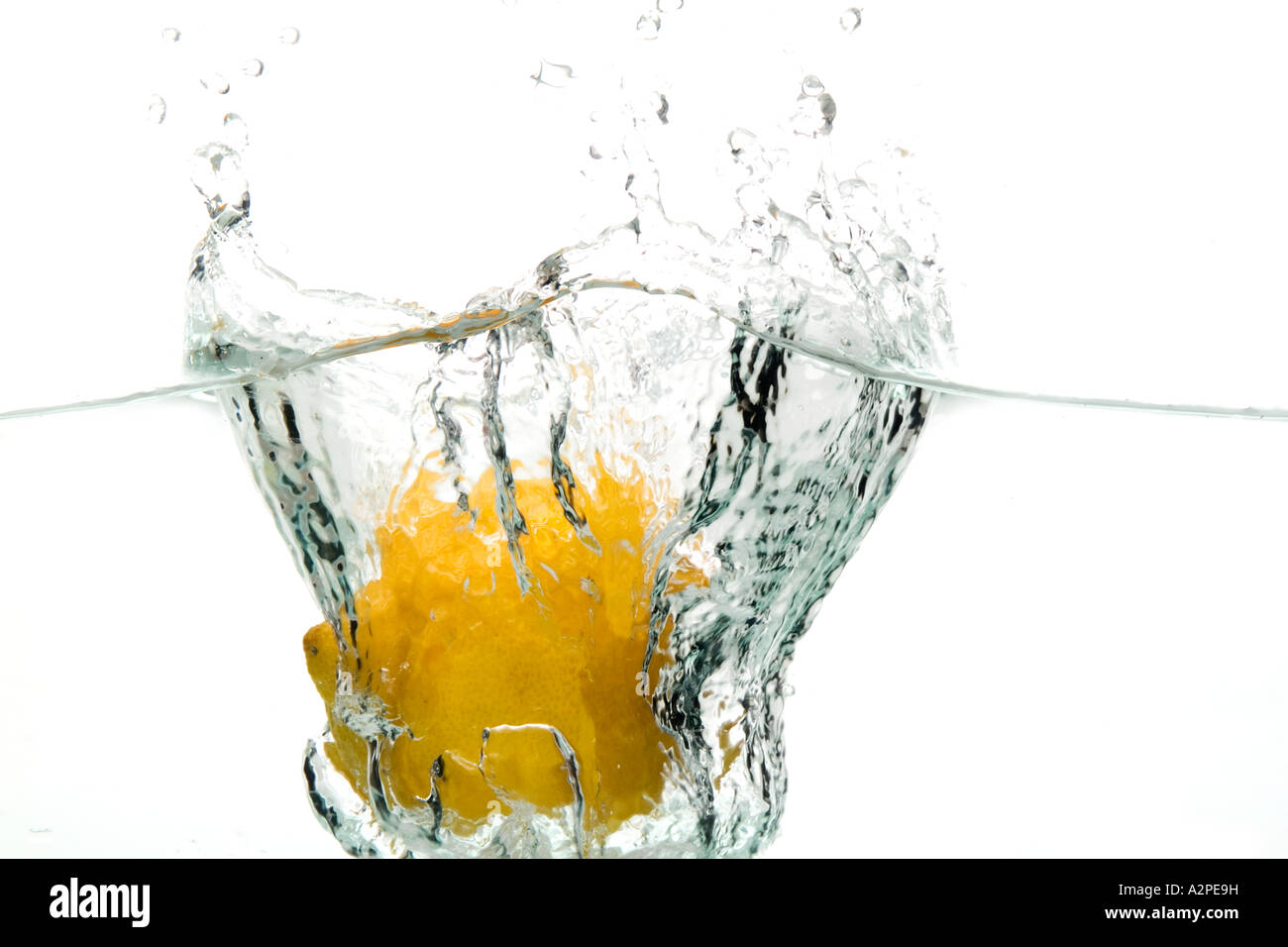 lemon dropping into water Stock Photo - Alamy
