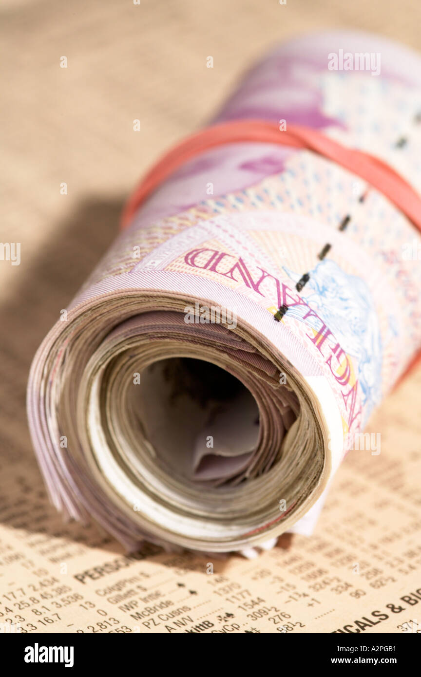 Close up view of Roll of english currency notes on stock market price ...