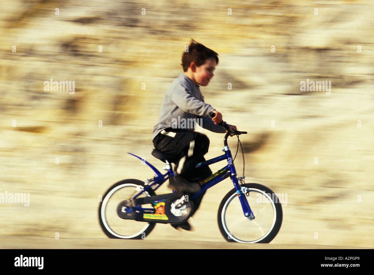 Young boy riding bicycle Stock Photo - Alamy