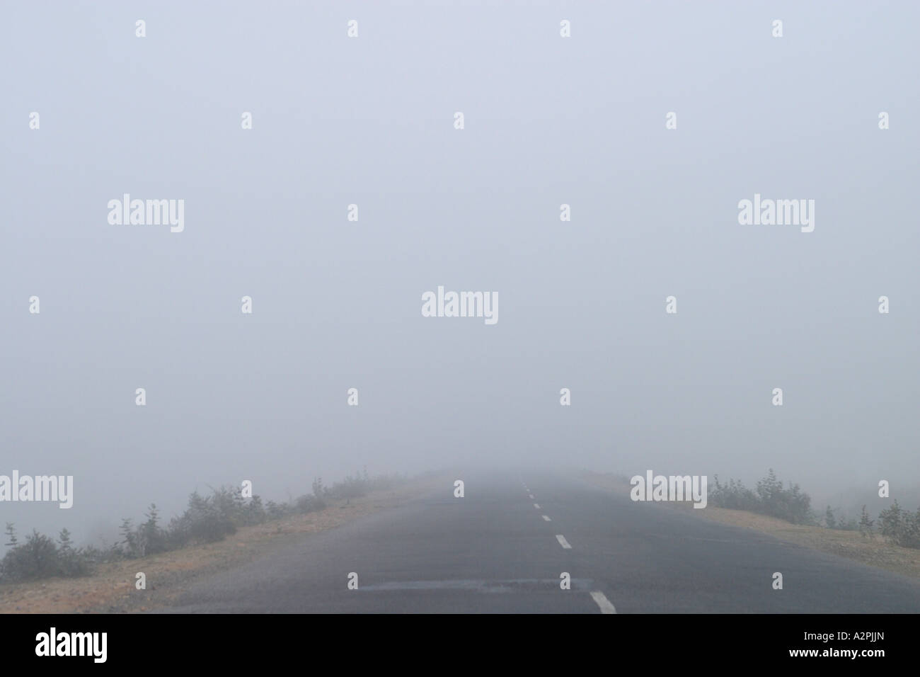 Roadway dissappears into swirling fog. Horizontal Stock Photo - Alamy