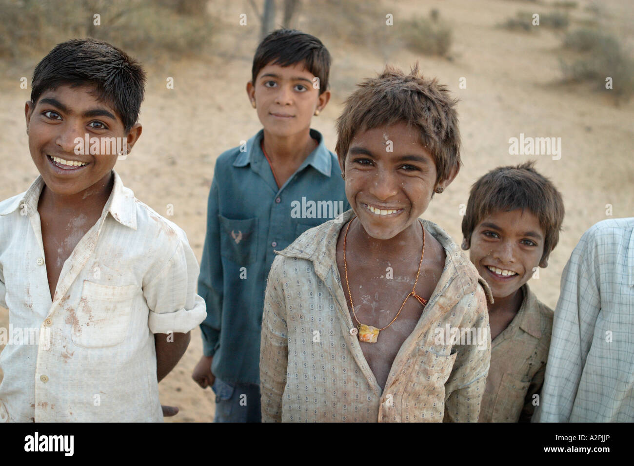 Young farm children greet passersby along the roadside in the Thar ...