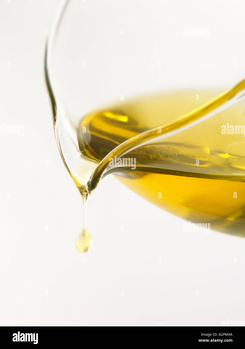 pouring olive oil from a glass jug Stock Photo - Alamy