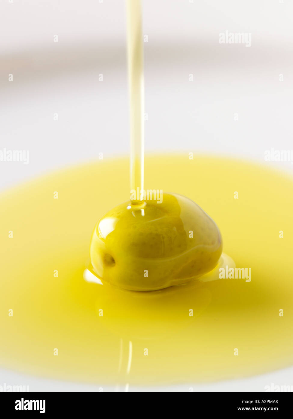 pouring extra virgin olive oil onto a green olive Stock Photo - Alamy