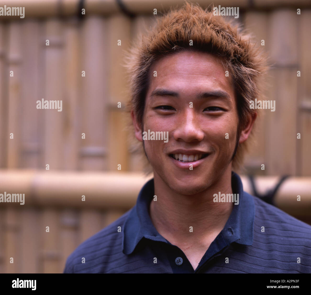 Young Japanese man with dyed hair visiting Kinkakuji temple Stock Photo ...