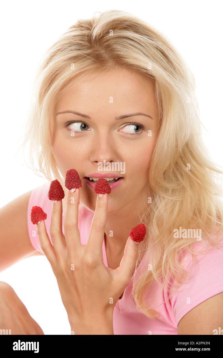 Woman eating raspberries off fingers Stock Photo - Alamy