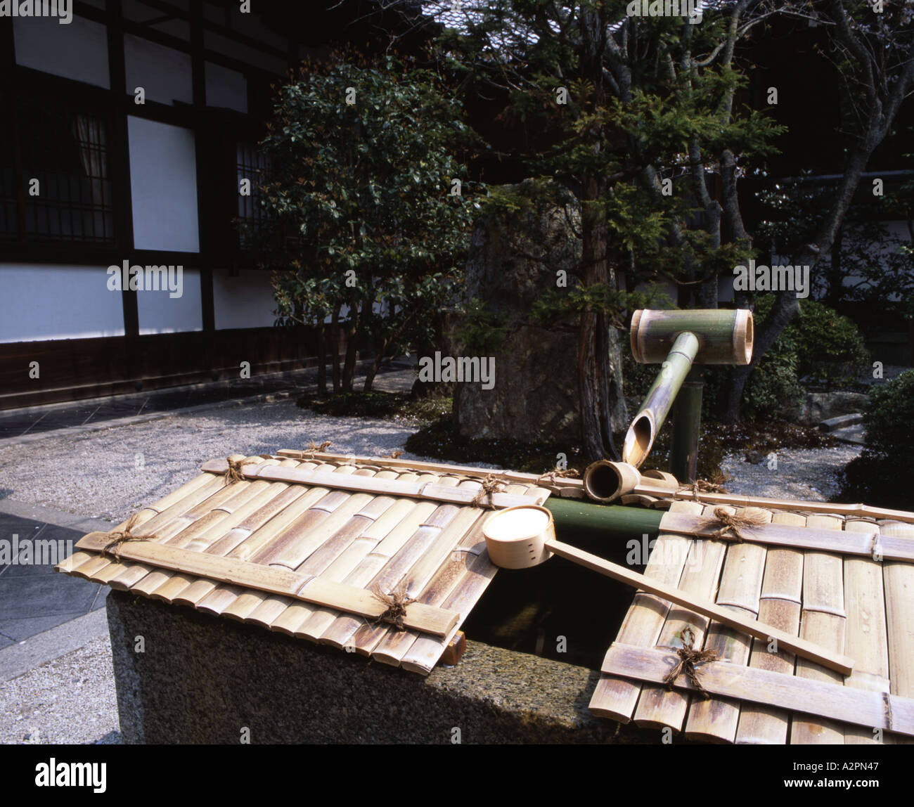 Water for purification as people enter shrine Fushimi Inari Shrine ...