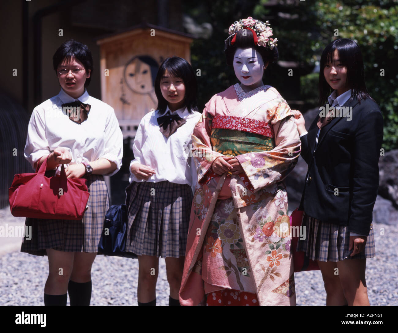 Japanese Junior High School students pose next to Girl in maiko trainee ...