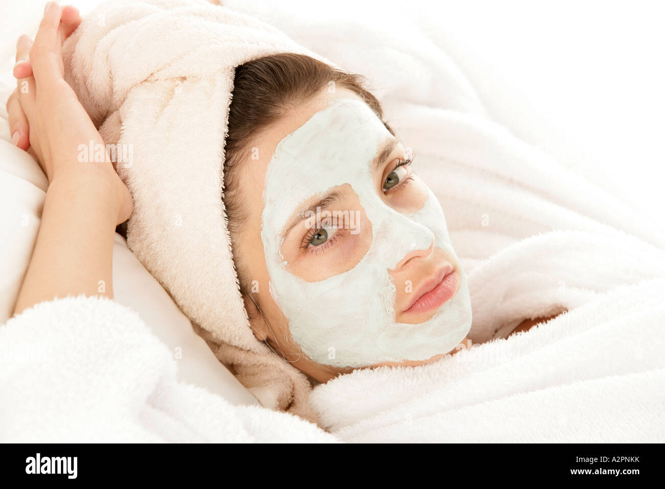 Woman wearing mask lying on bed Stock Photo - Alamy