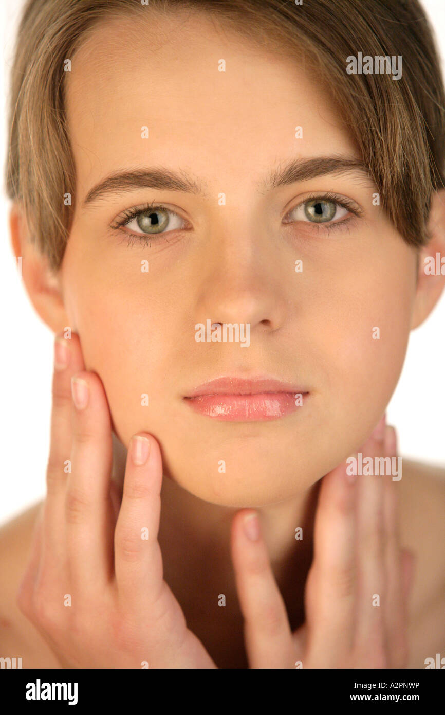 Young woman touching her cheek Stock Photo - Alamy