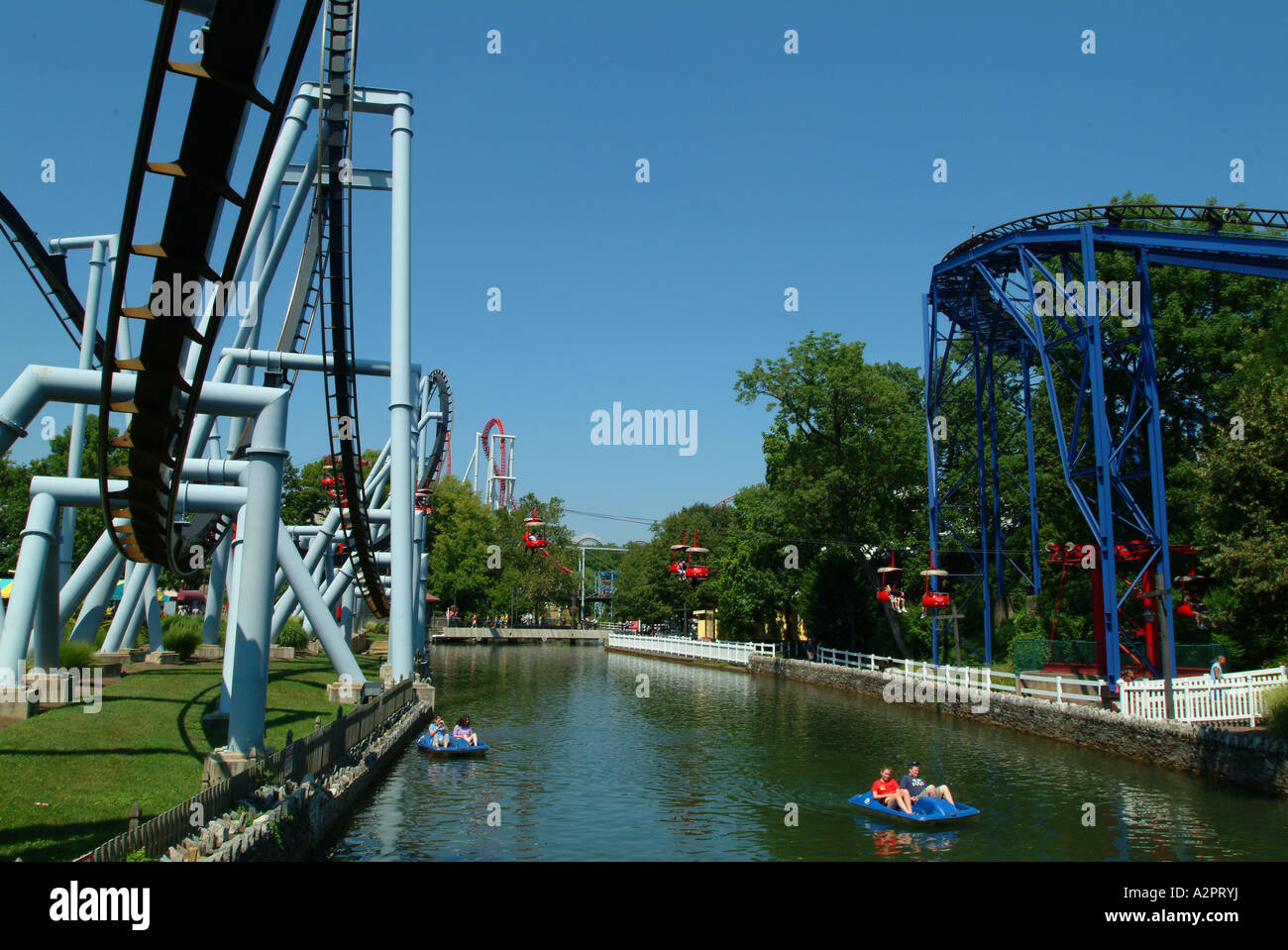 Paddle boats on a waterway between two roller coasters Stock Photo - Alamy