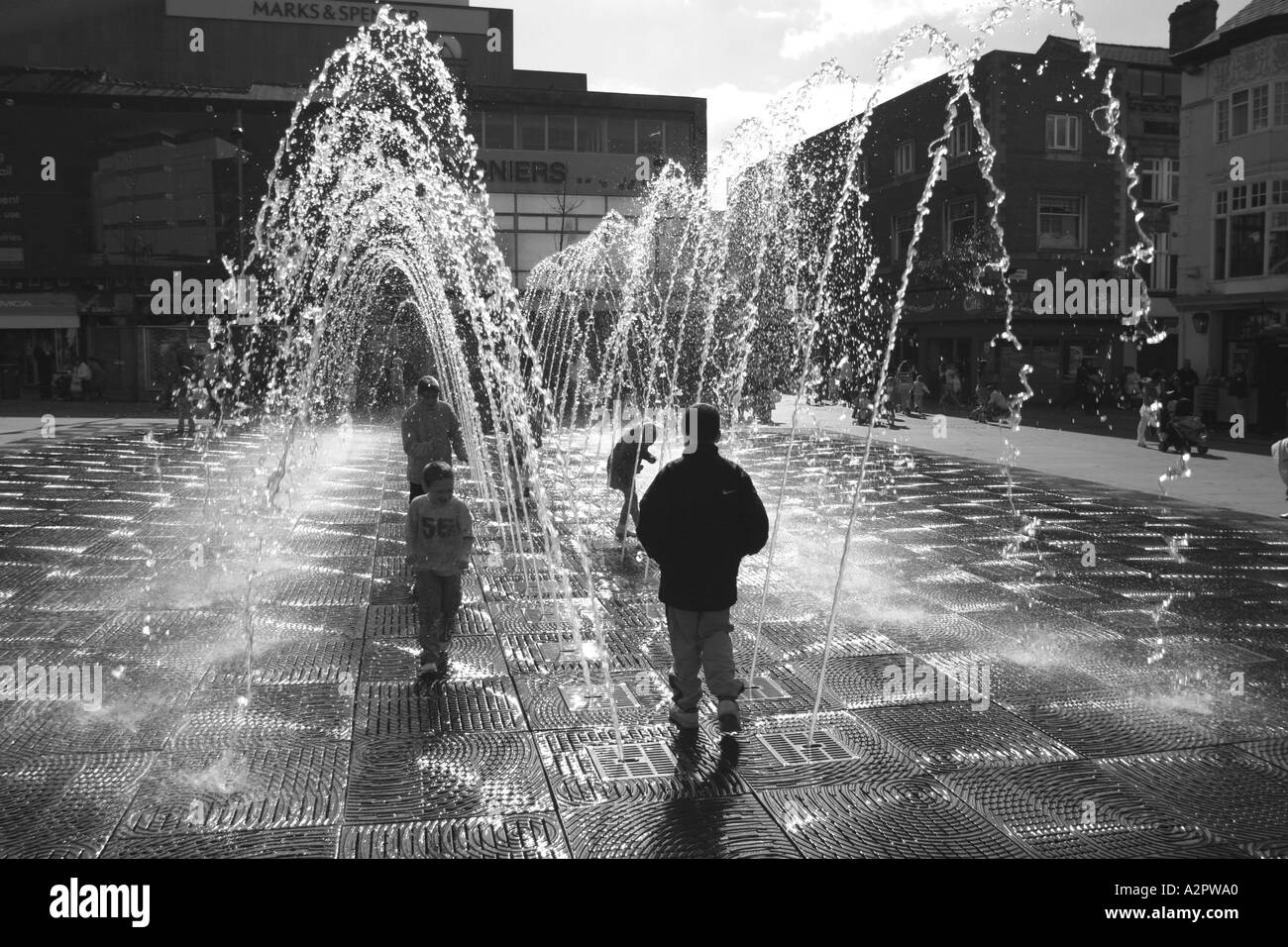 Children playing water fountain Black and White Stock Photos & Images ...