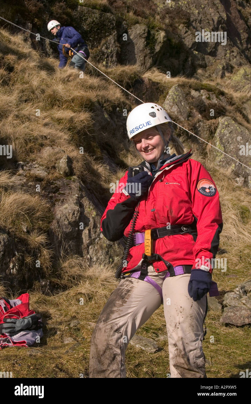 a female member of a mountain rescue team communicates with her radio ...