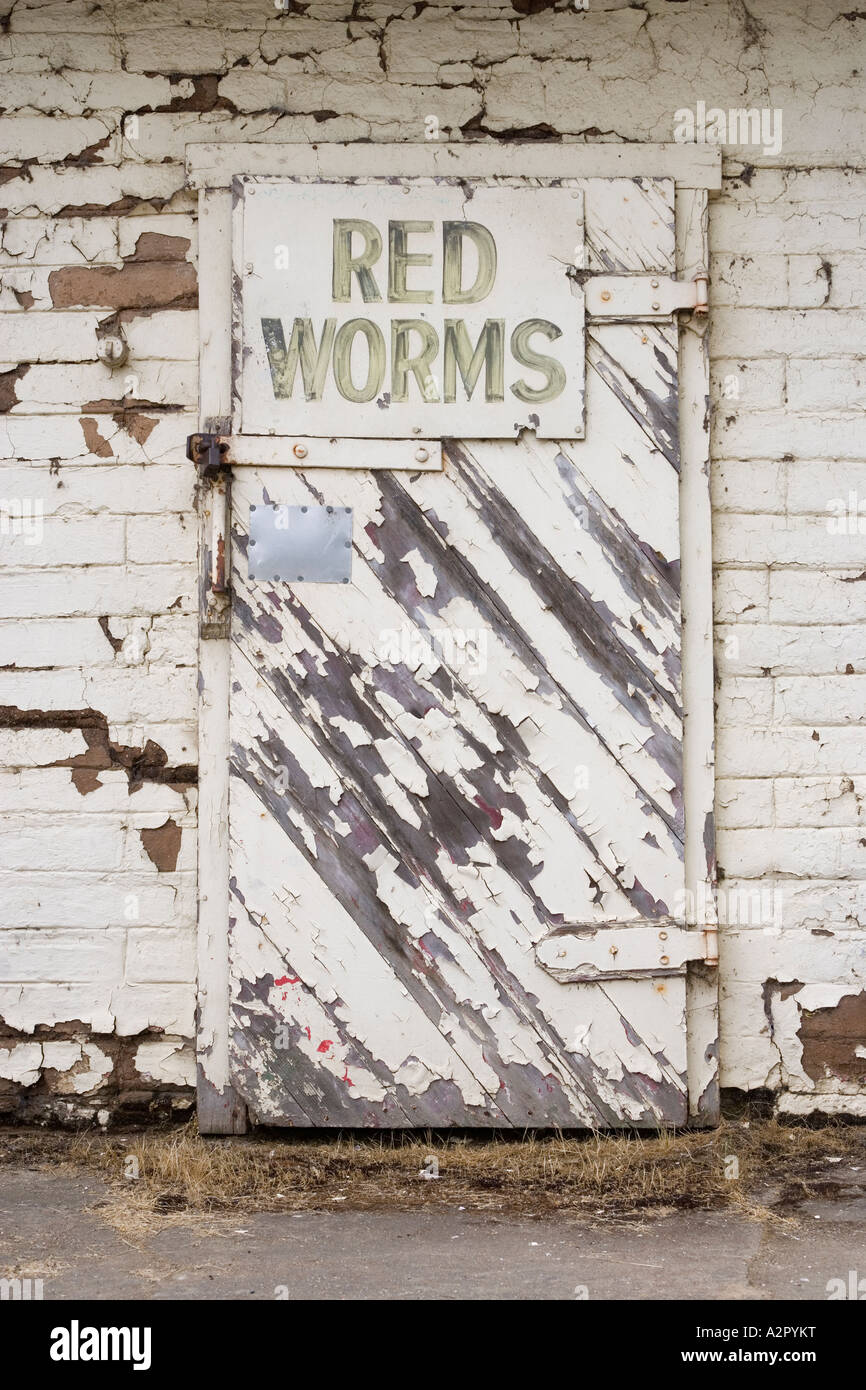 Red Worms Sign on Shack Door Stock Photo - Alamy