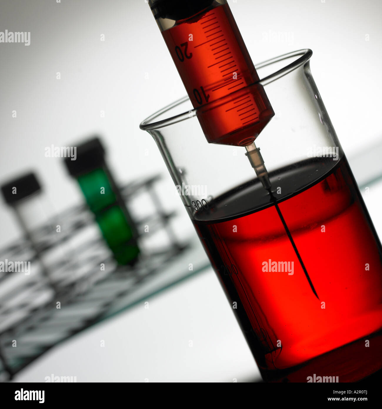 Syringe with Shelf in Background with Glassware Stock Photo - Alamy