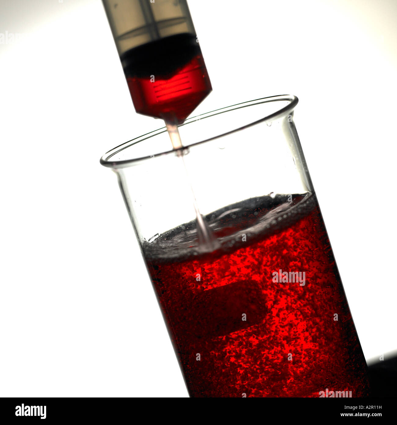 Beaker with Syringe Stock Photo - Alamy