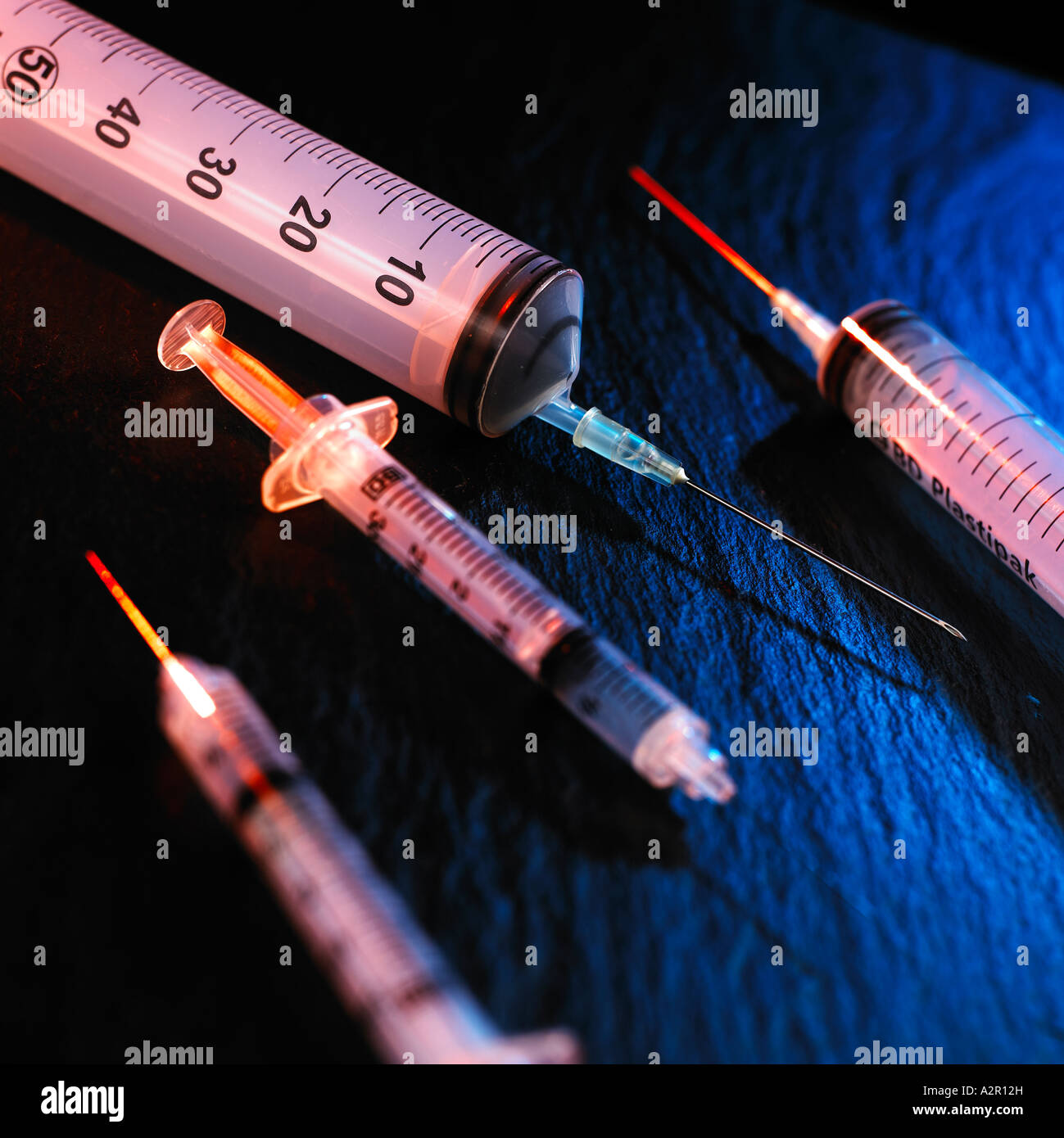 Group of Syringes on blue slate background Stock Photo - Alamy