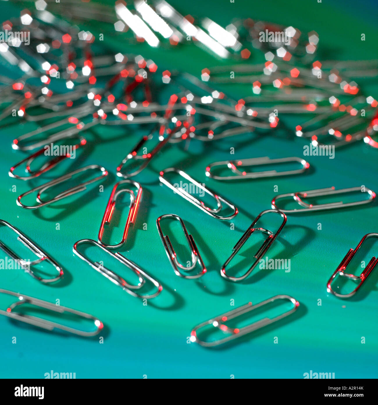 Group of Paper Clips on Blue/Green Background Stock Photo - Alamy