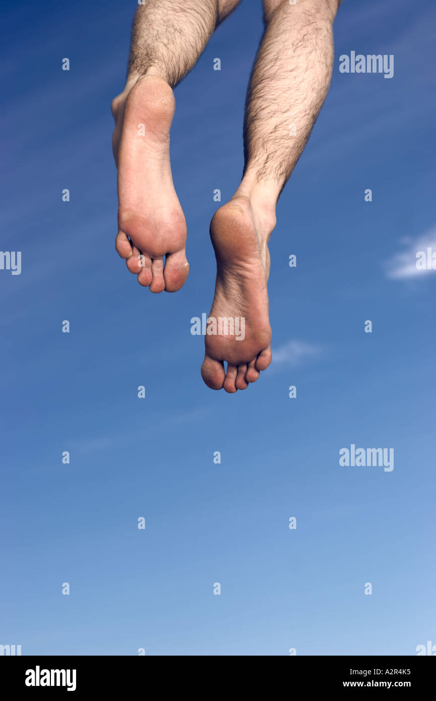 Legs flying up to a blue sky with some clouds Stock Photo - Alamy