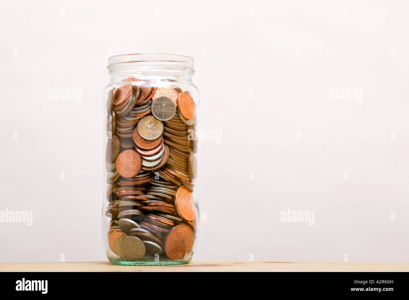 Glass jam jar filled with loose change Stock Photo - Alamy