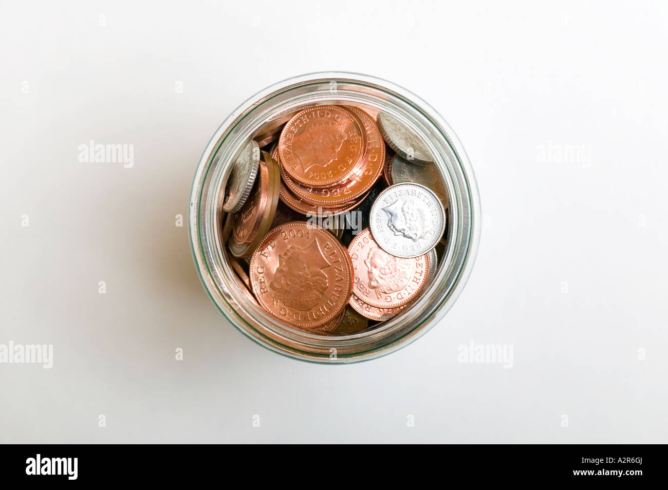 Glass jam jar filled with loose change Stock Photo - Alamy