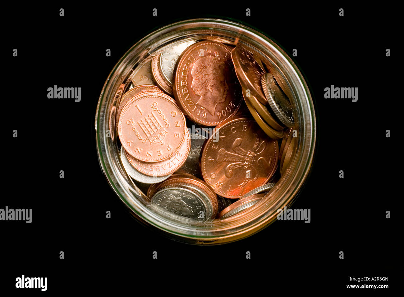 Glass jam jar filled with loose change Stock Photo - Alamy