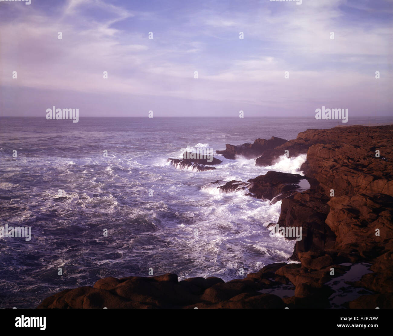 Sunset colors suffuse the view at Boiler Bay State Park on the Oregon ...