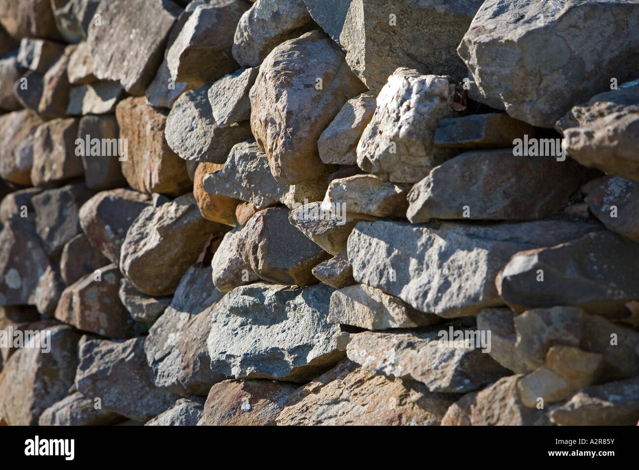 Close up of stacked field stone wall Stock Photo - Alamy