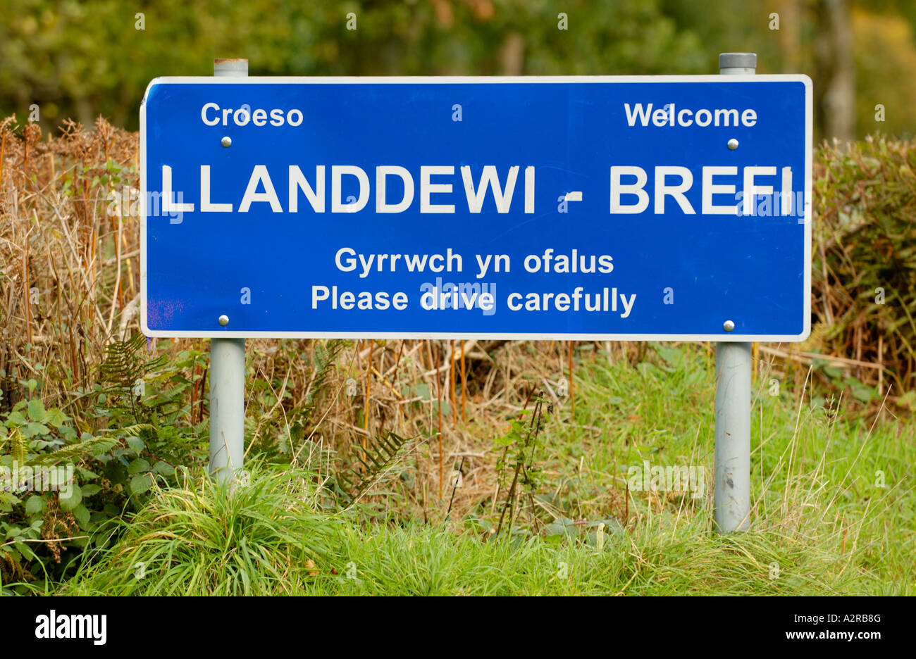 Bilingual Welsh English language blue WELCOME sign outside the village ...