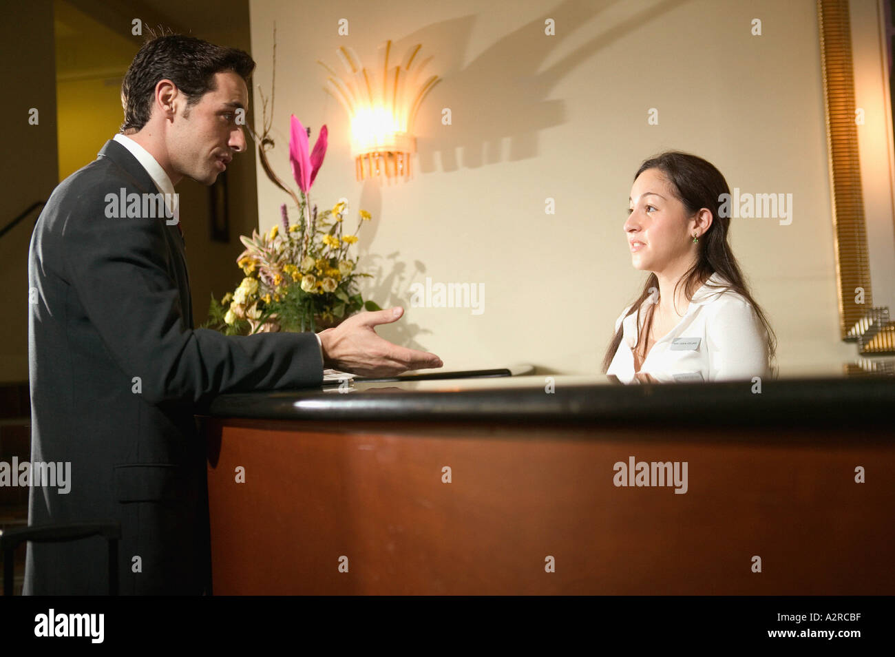 Hotel receptionist talking businessman woman hi-res stock photography ...