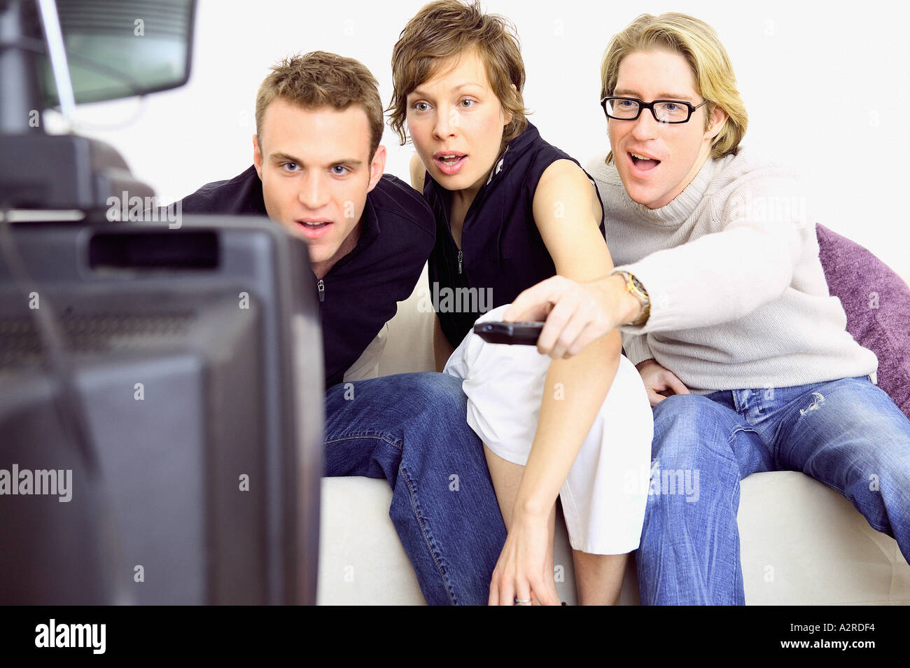 Friends watching television Stock Photo - Alamy