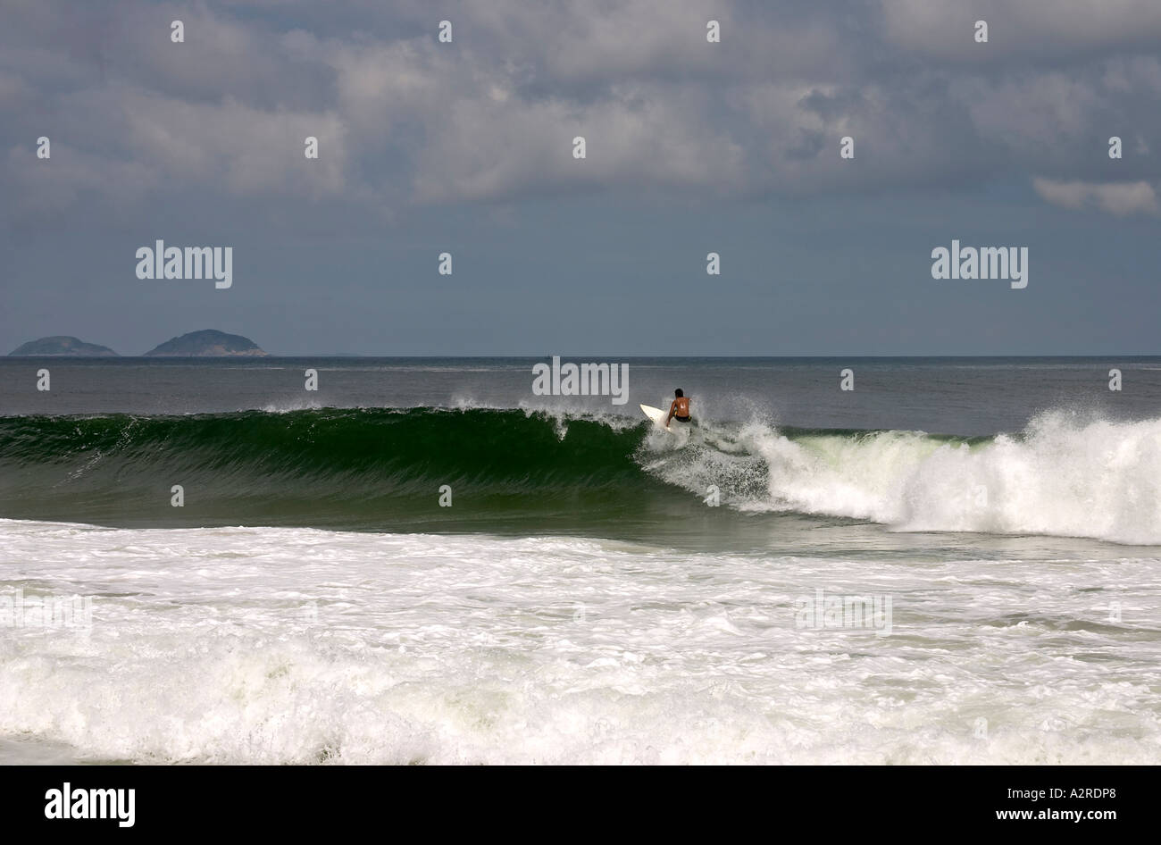 A Surfer Surfing on rolling surf wave Copacabana beach Rio de Janeiro ...