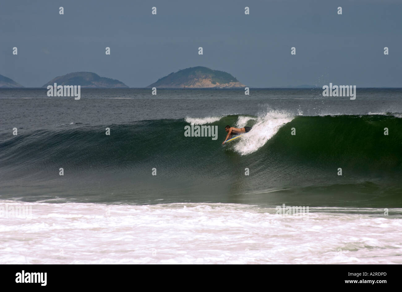A Surfer Surfing on rolling surf wave Copacabana beach Rio de Janeiro ...