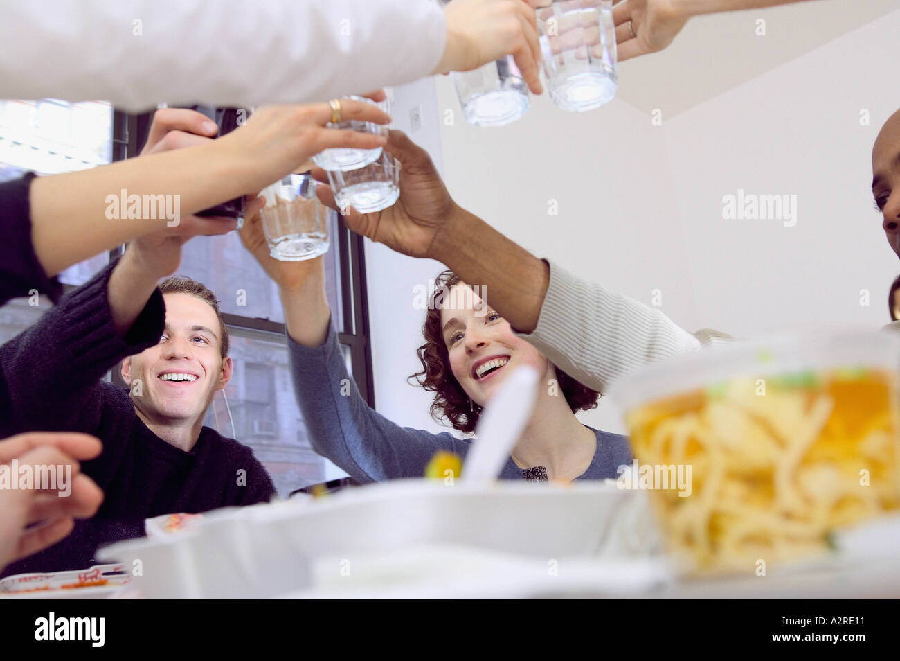 Friends eating fast food at table Stock Photo - Alamy