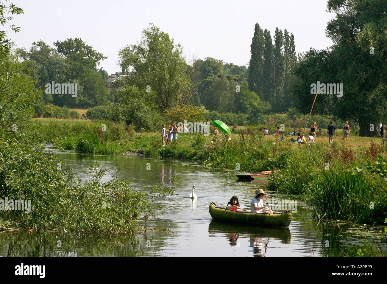 People canoeing and picnicing and fishing by River Cam Grantchester ...