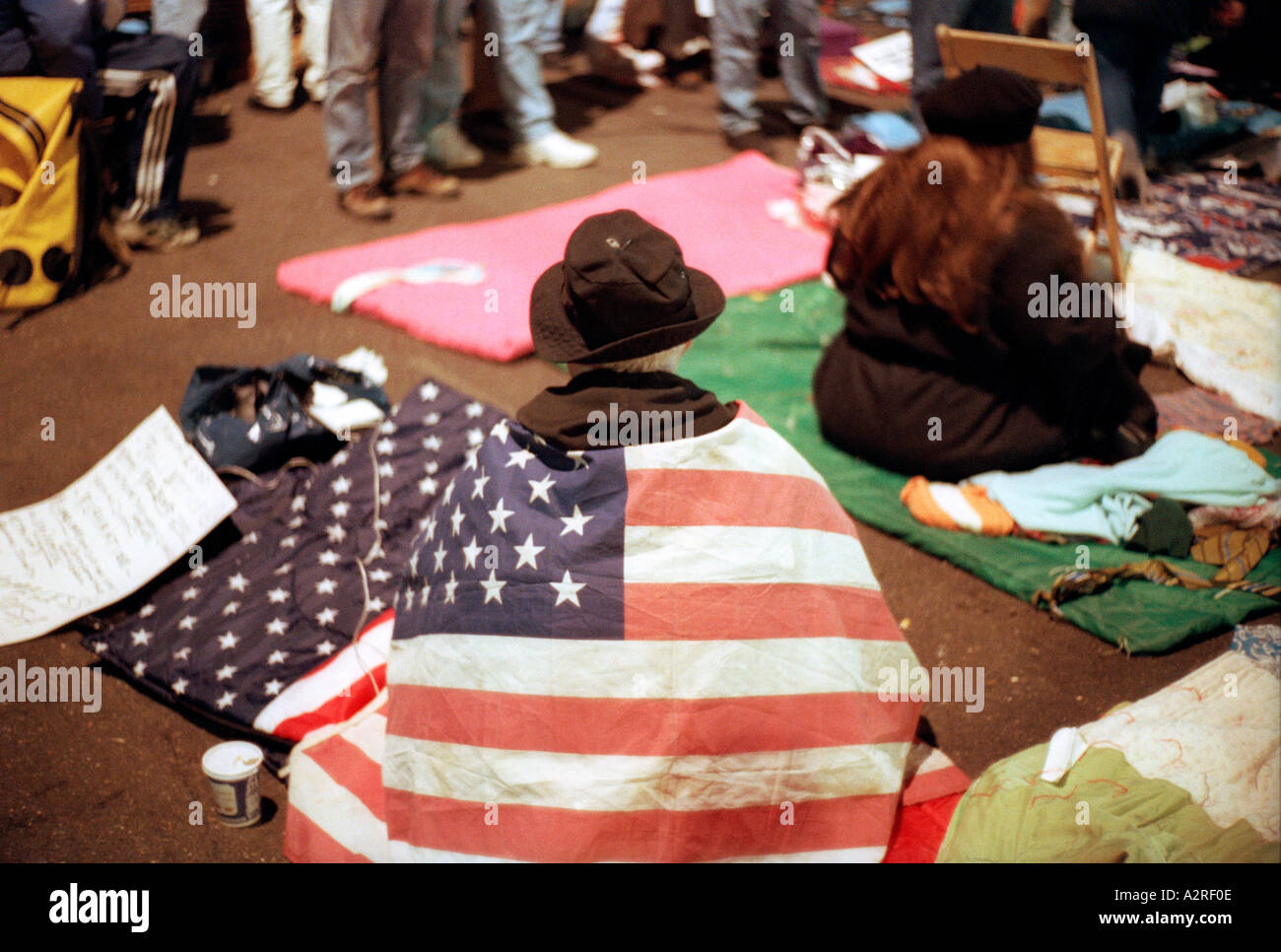 A homeless activist wrapped in an American Flag in Union Square Park ...