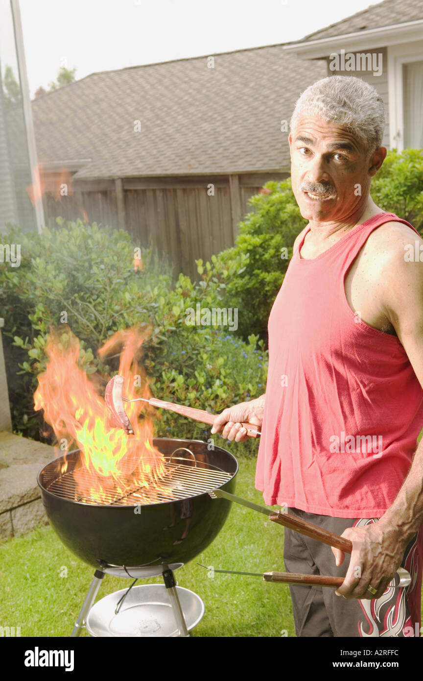 A man grilling in his backyard Stock Photo - Alamy