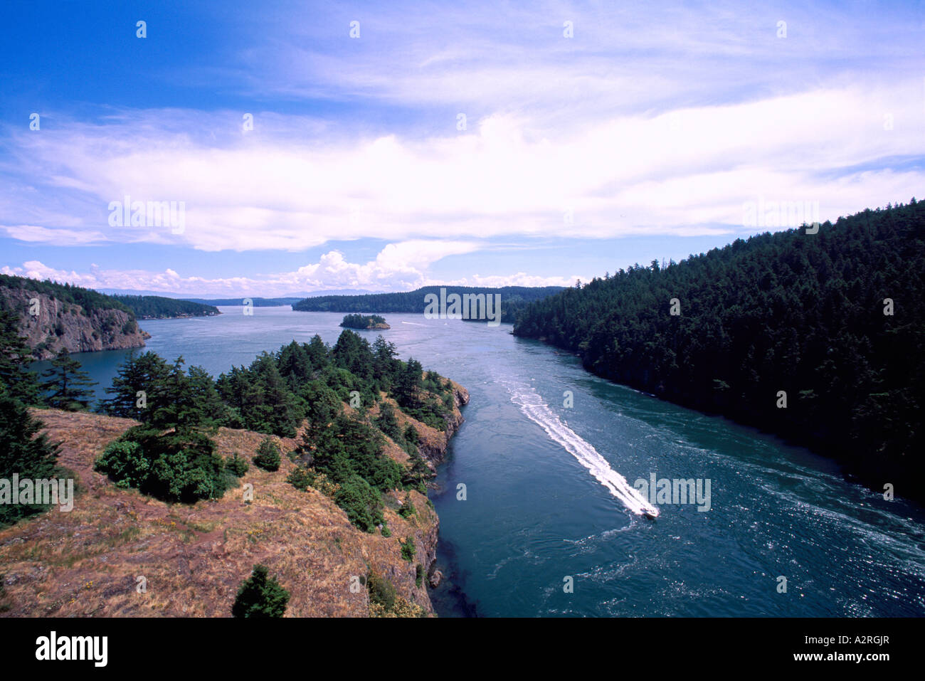 Boat navigating through Deception Pass at North End of Whidbey Island ...